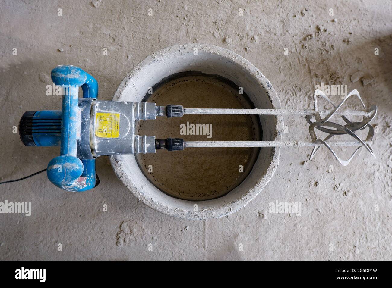 the construction mixer lies on a container with a solution Stock Photo ...