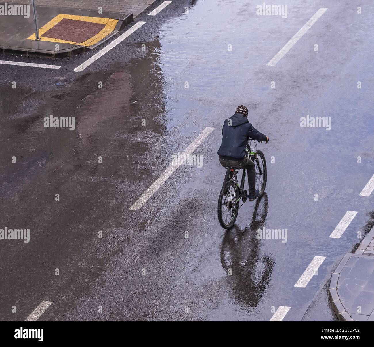 Aerial view of a man riding a bike in the rain Stock Photo - Alamy