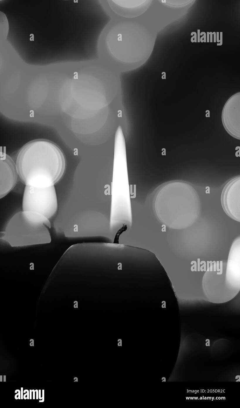 Candle lights in darkness with colorful light effects and bokeh for ...