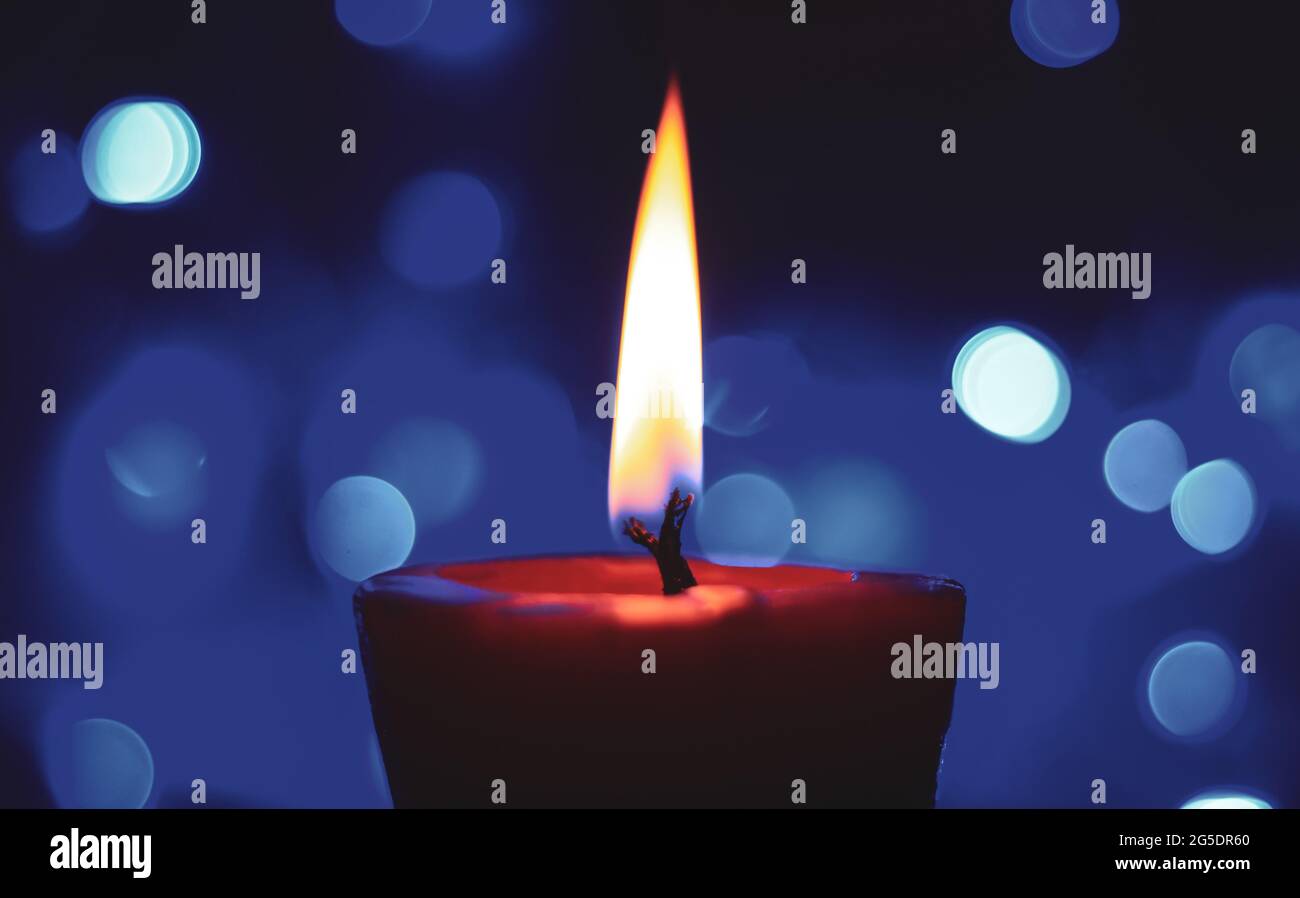 Candle lights in darkness with colorful light effects and bokeh for ...
