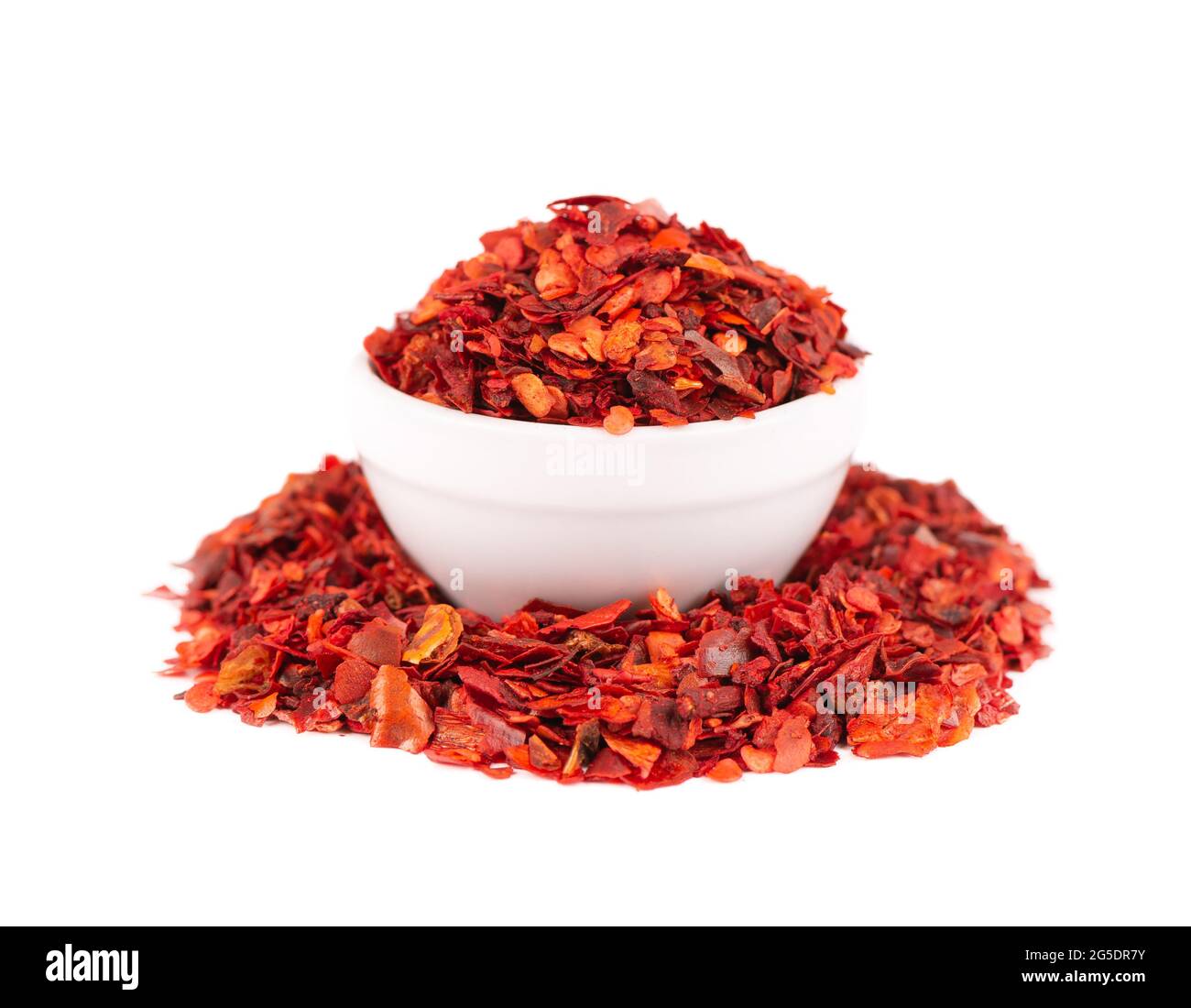 Dried red chili flakes in bowl, isolated on white background. Chopped ...