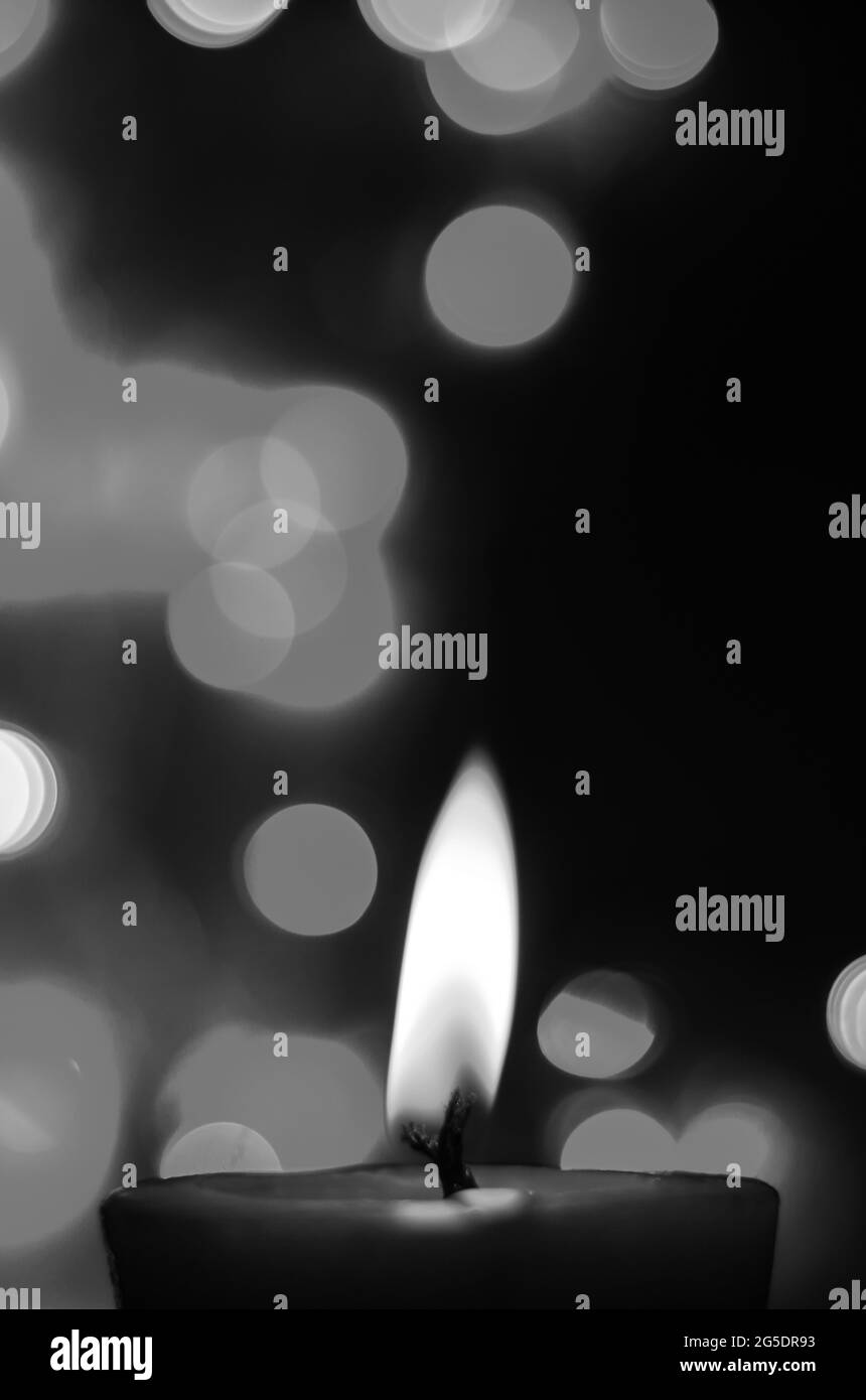 Candle lights in darkness with colorful light effects and bokeh for ...