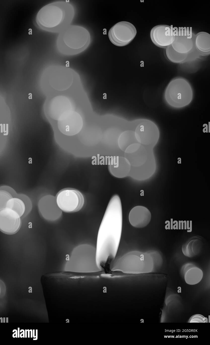 Candle lights in darkness with colorful light effects and bokeh for ...