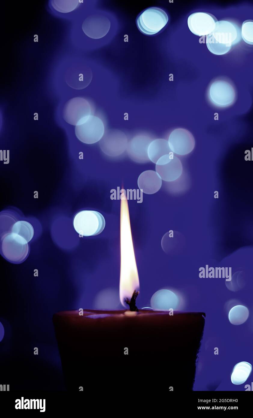 Candle lights in darkness with colorful light effects and bokeh for ...