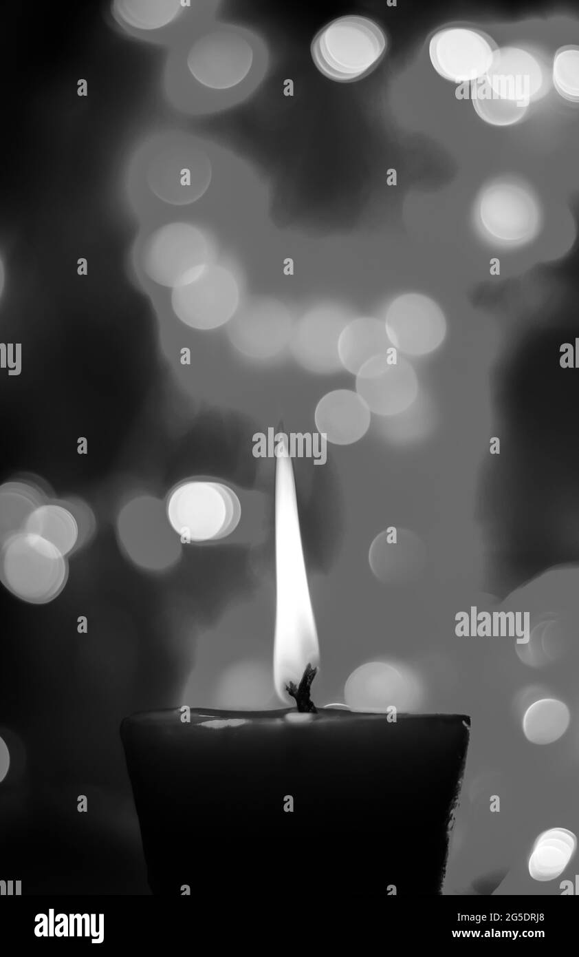 Candle lights in darkness with colorful light effects and bokeh for ...