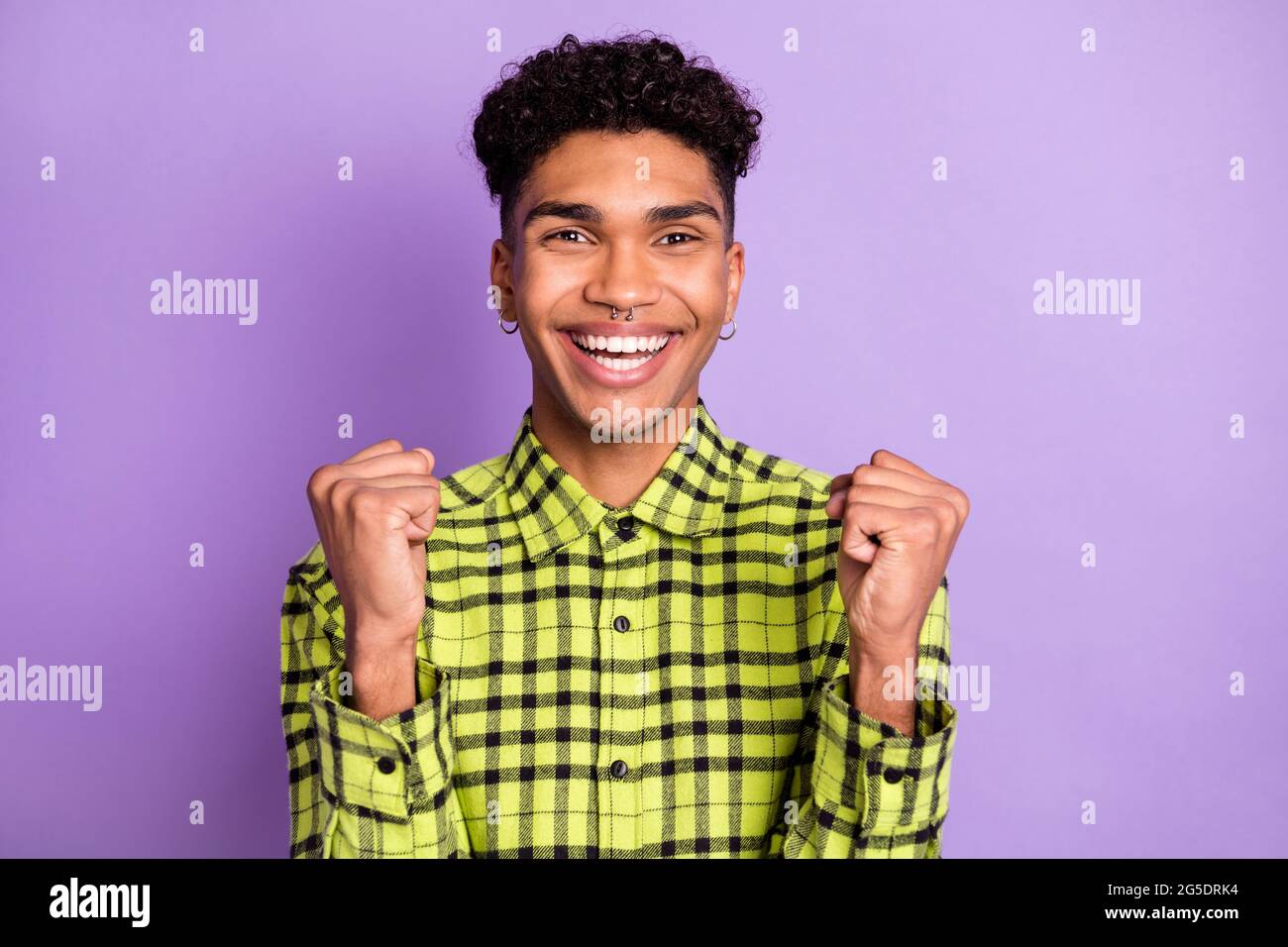 Photo of lucky charming dark skin brunette man raise fists good mood ...