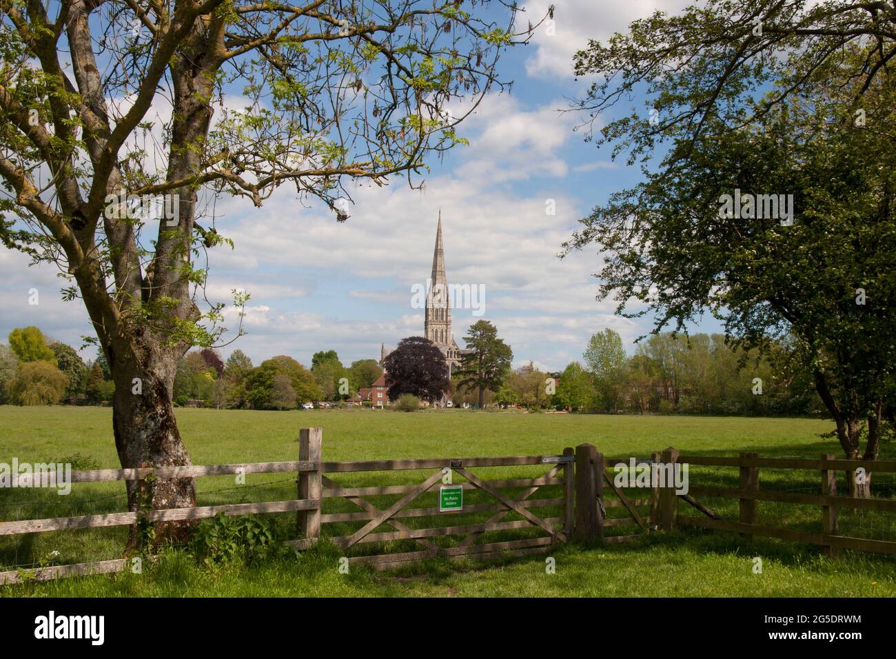 Salisbury Cathedral as seen through a gate from the Harnham water ...