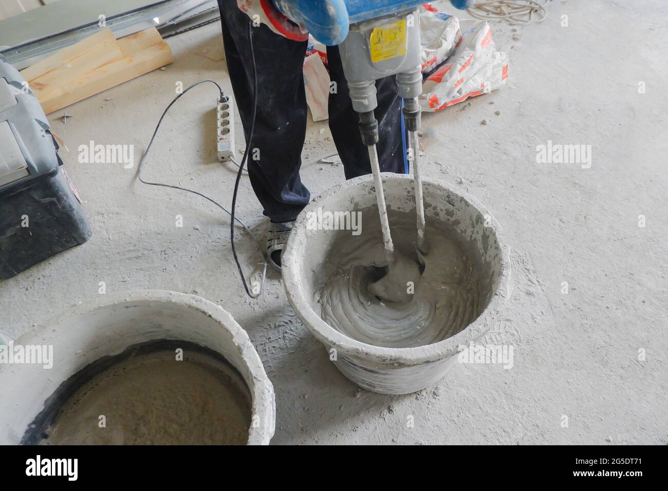 the builder mixes the construction mixture in a container for guiding ...