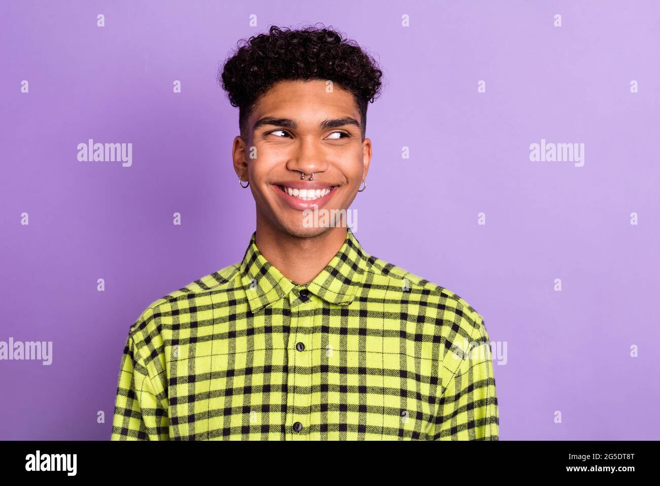 Photo portrait of guy curious looking blank space in checkered shirt ...