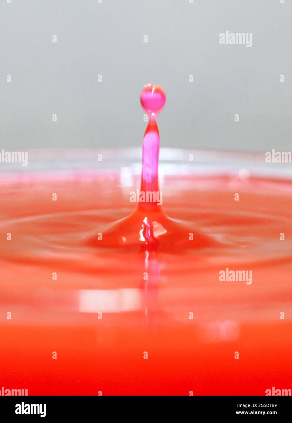 close up of colorful water droplets falling. Waterdrop splash into the ...