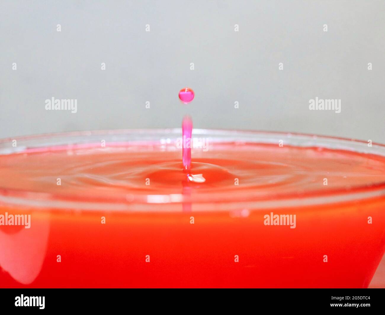 close up of colorful water droplets falling. Waterdrop splash into the ...