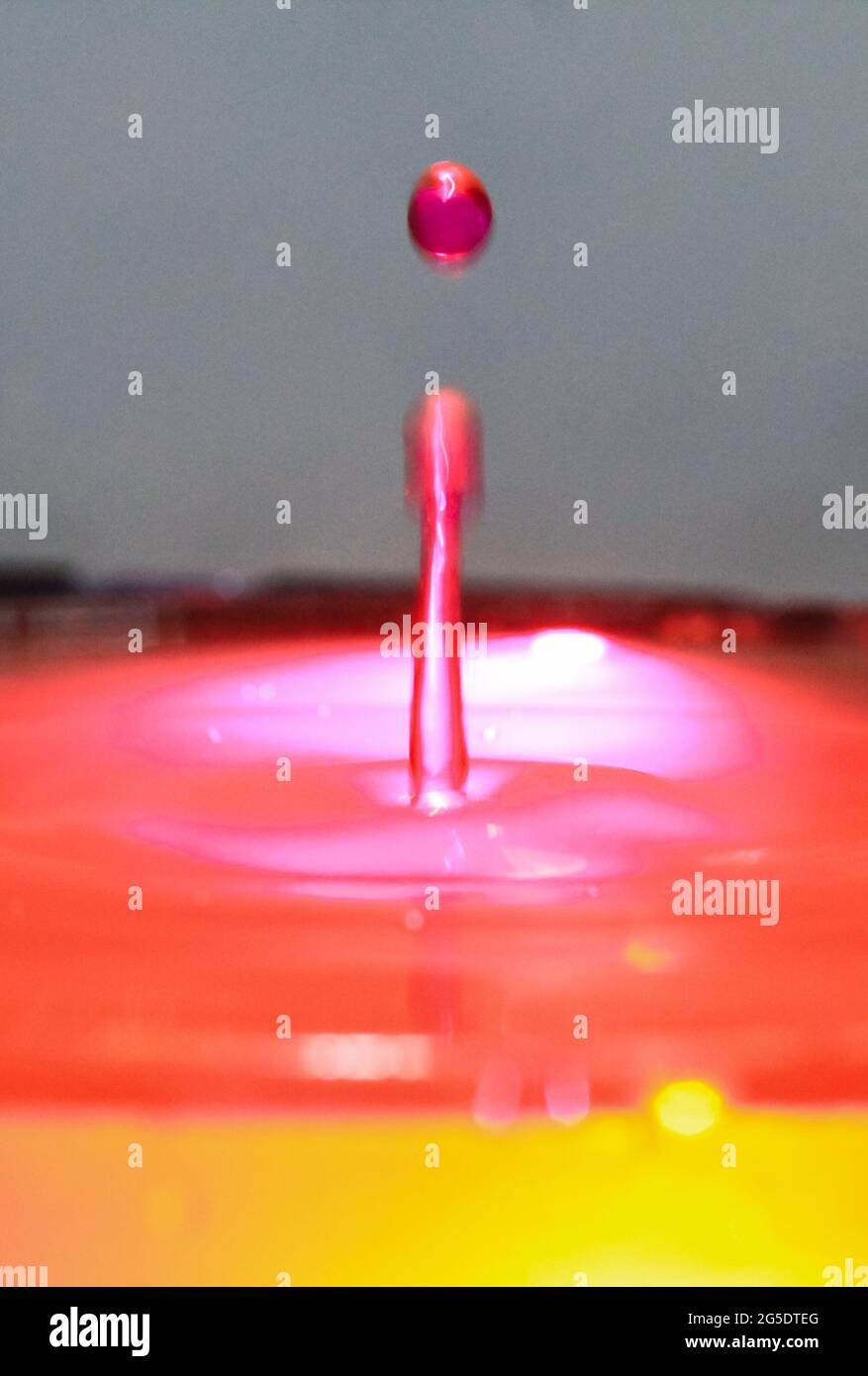 close up of colorful water droplets falling. Waterdrop splash into the ...