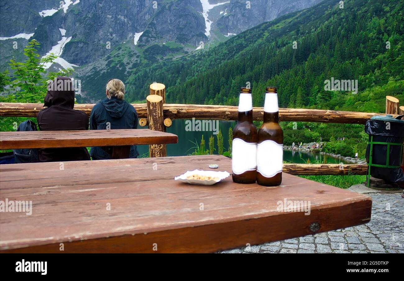 Two bottle of unbranded alcoholic beverage with white label next to ...