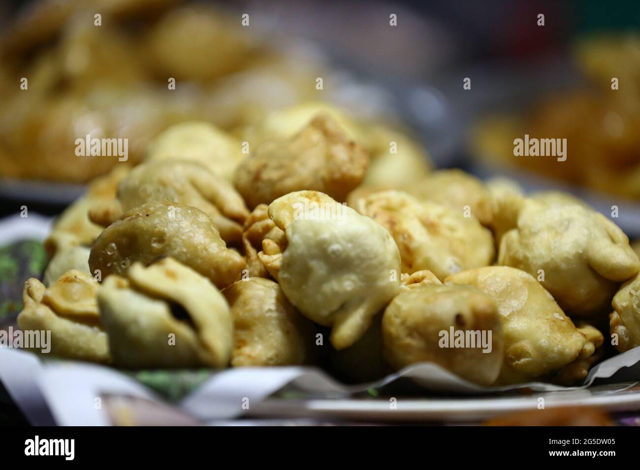 Crispy deep fried Singaras on an aluminium bowl. As a traditional food ...