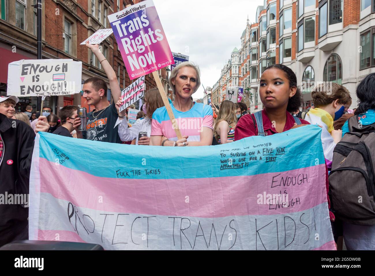 London, UK. 26th June, 2021. Protestors seen with a banner that says ...