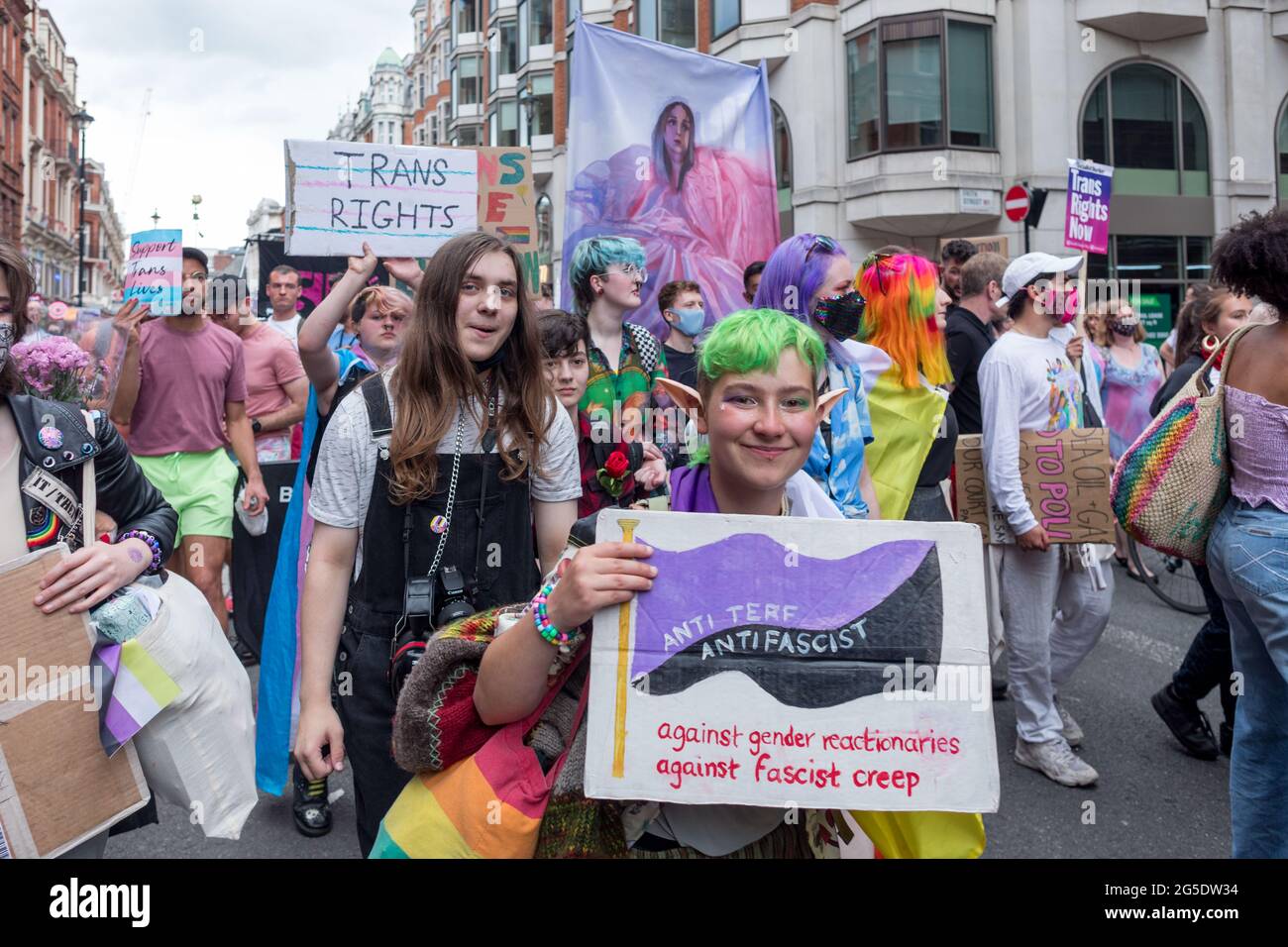 A protestor holds up a placards that says 'anti terf, antifascist ...