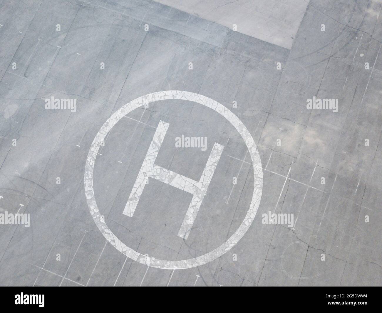helicopter helipad on the asphalt surface with letter "H" view from ...