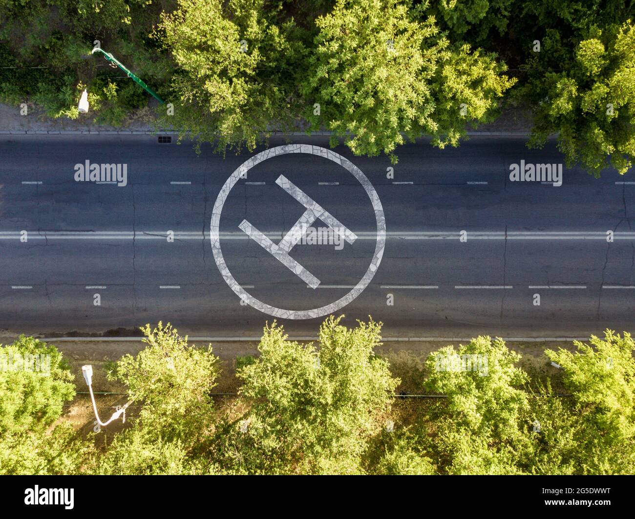 helicopter helipad on the asphalt surface with letter "H" view from ...