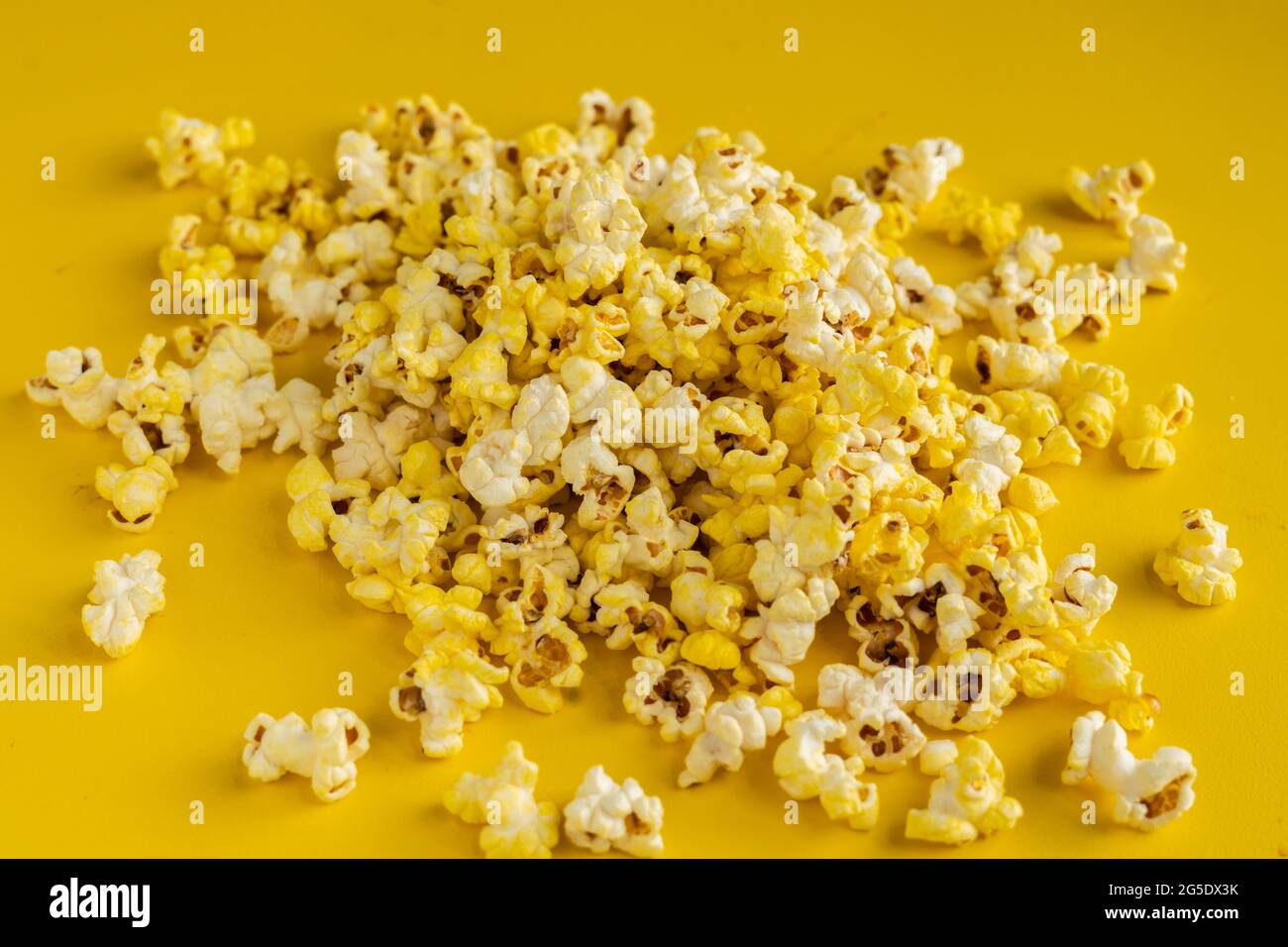 a bunch of popcorn dropped on the color surface flat lay Stock Photo ...