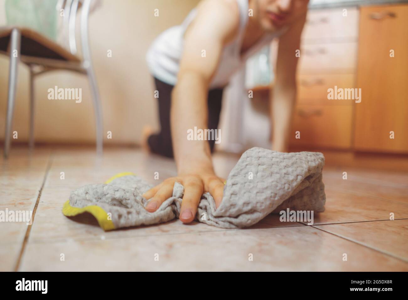 single man cleaning his house, washing the floor by himself, household ...