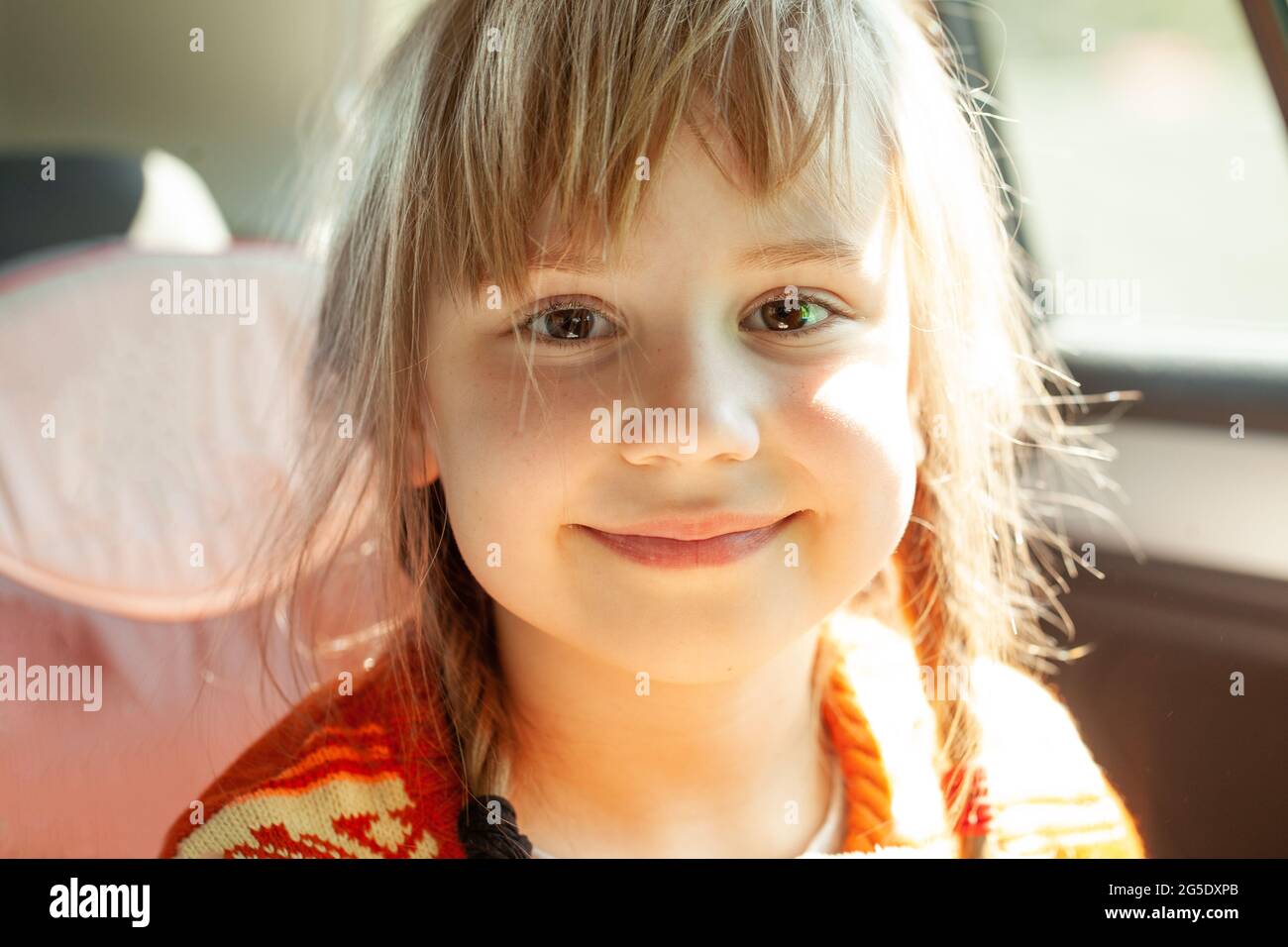 Cute little girl sitting in car seat and smiling. Travel and child ...