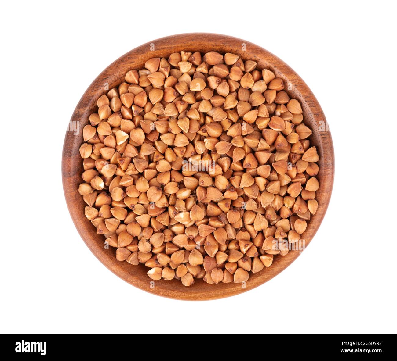 Roasted buckwheat grains in wooden bowl, isolated on white background ...