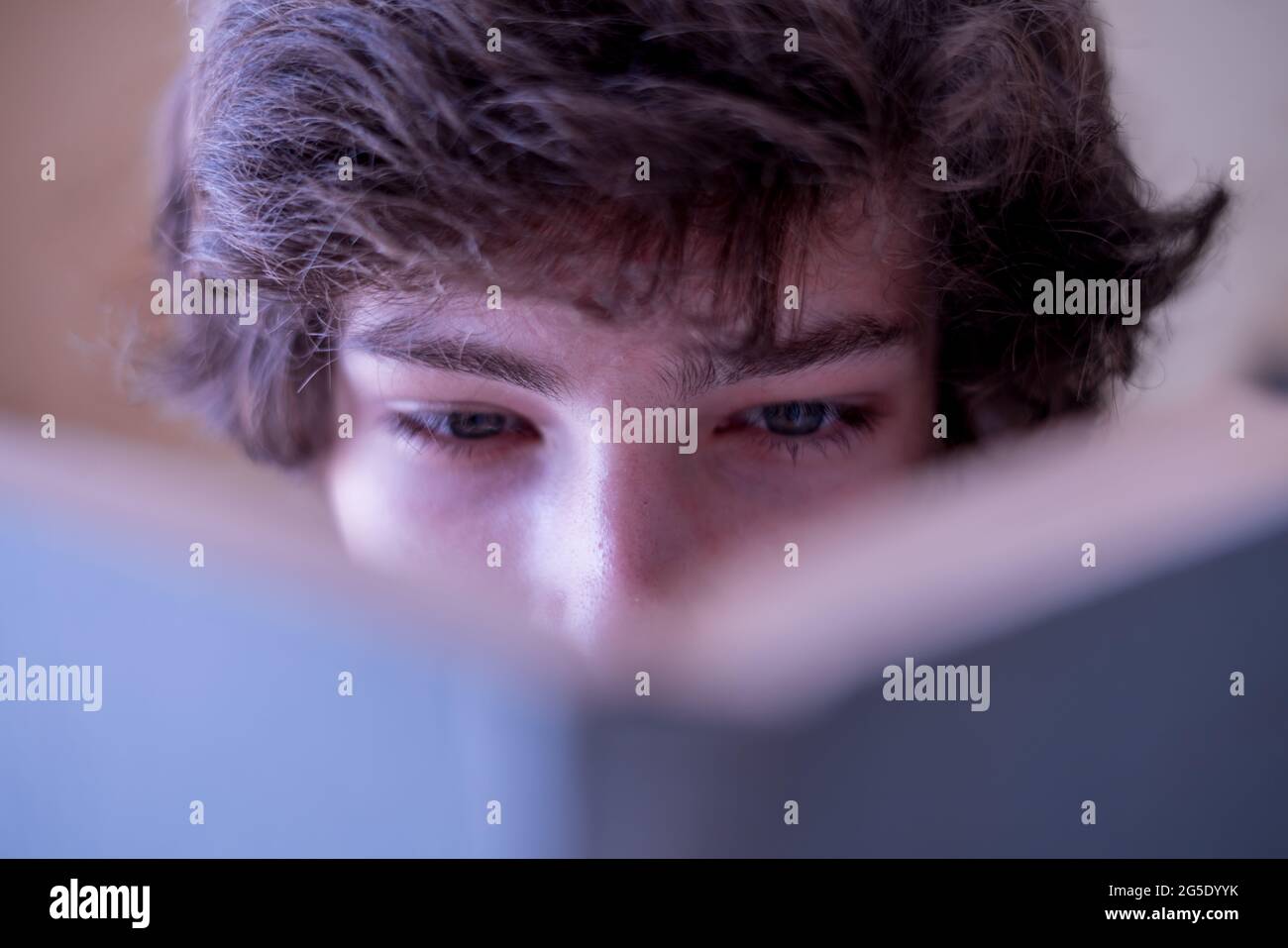 close up view of man's eyes looking in the book, careful reading Stock ...