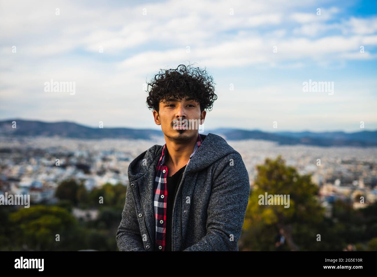 Young exotic boy model posing on the street Stock Photo - Alamy