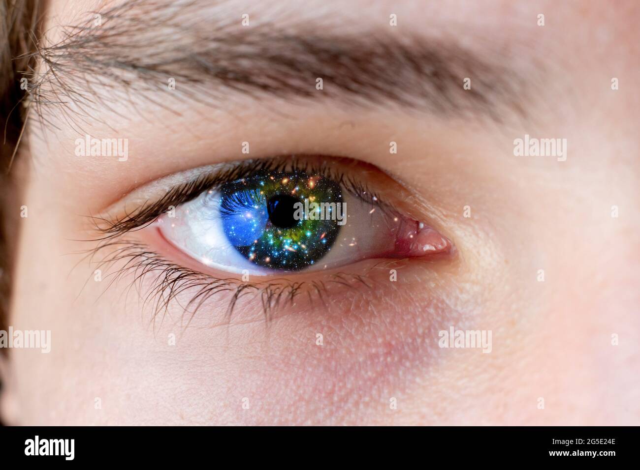 macro shot of the person's eye with universe galaxy space inside ...