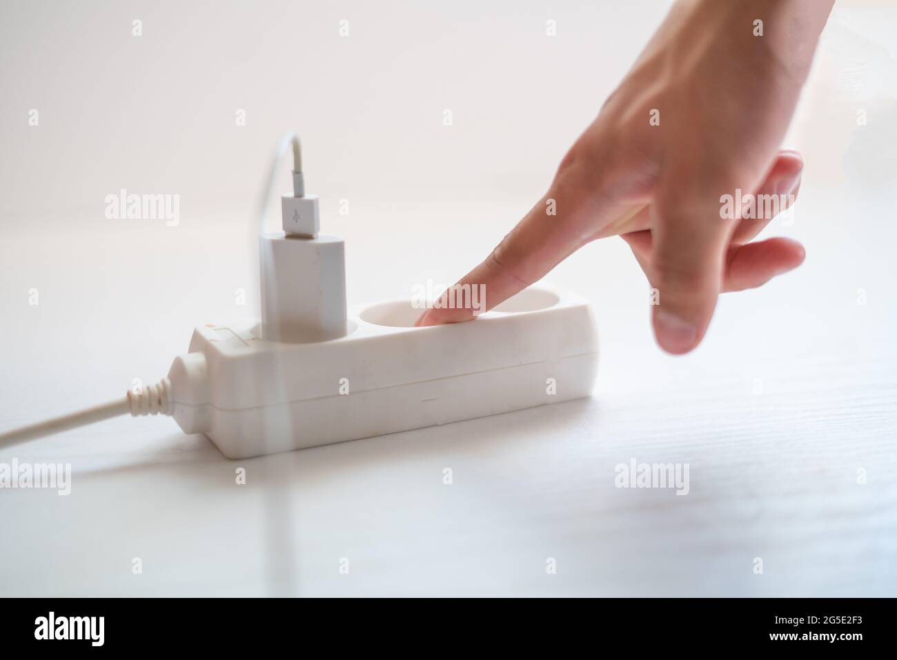 caution, hand insert the finger into the electricity socket, danger and ...