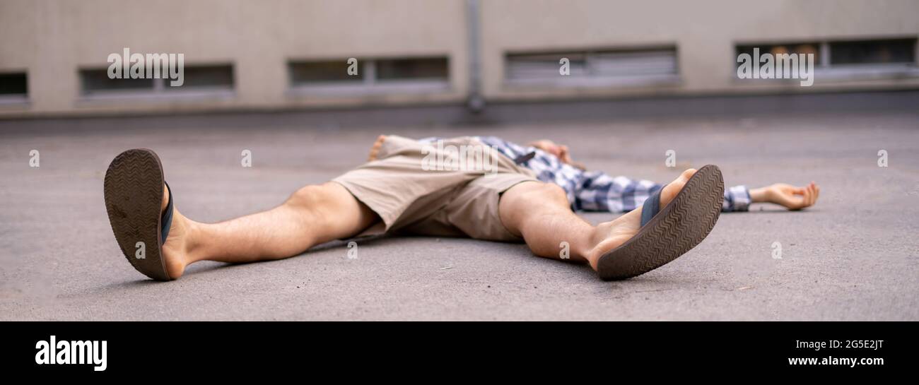 man on the ground, got injury outdoors, fall down Stock Photo - Alamy