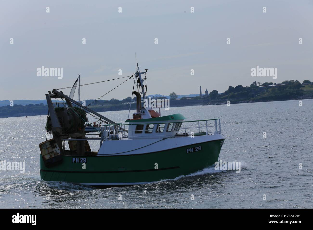 Fishing boat coming back to port Stock Photo - Alamy