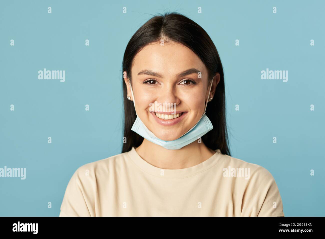 Brunette in blue disposable face hi-res stock photography and images ...