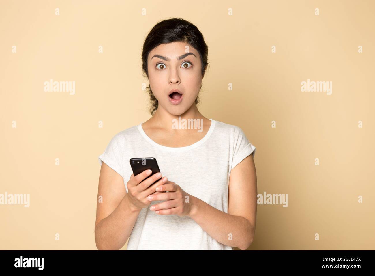 Portrait of stunned Indian woman shocked by unexpected message Stock ...