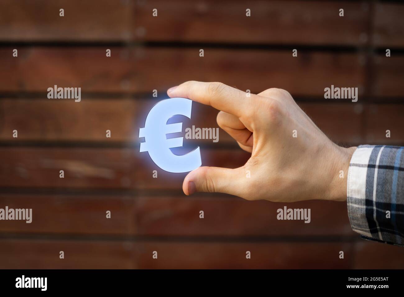 hand holding a euro sign, money increase symbol concept, financial ...