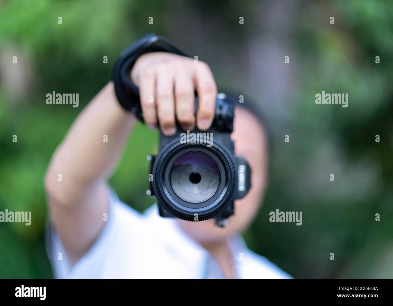Asian man holds the Medium Format Camera in his hand and focus to shoot ...