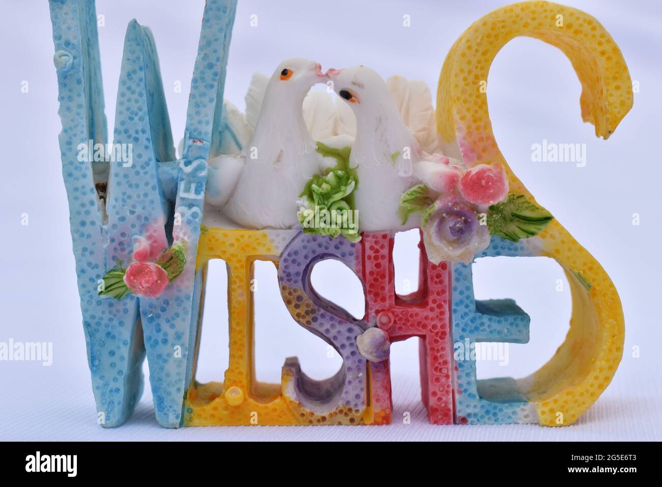 Small stone gift of colorful wishes word decorated with flowers ...