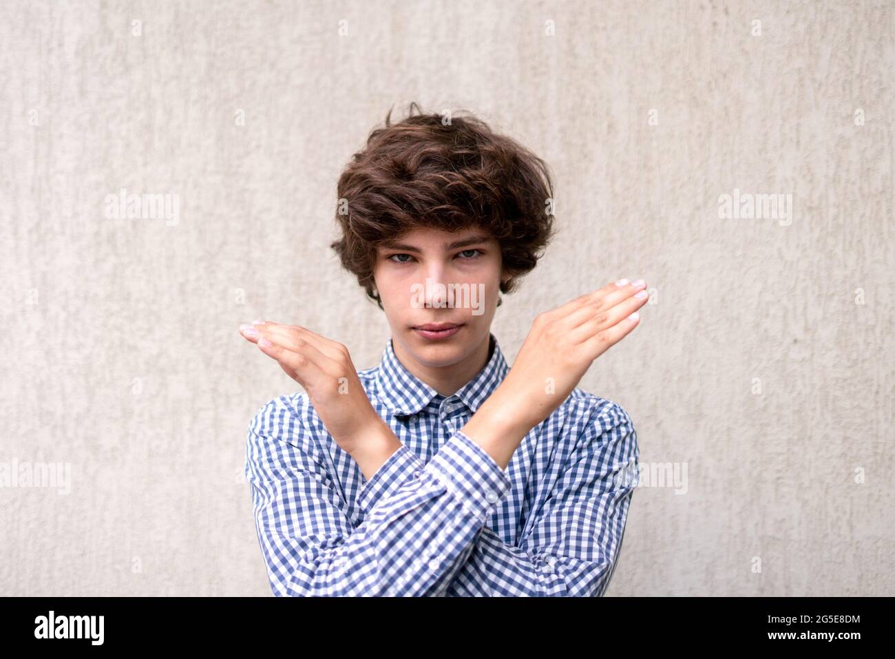 young man with crossed hands in front of face, stop gesture sign Stock ...