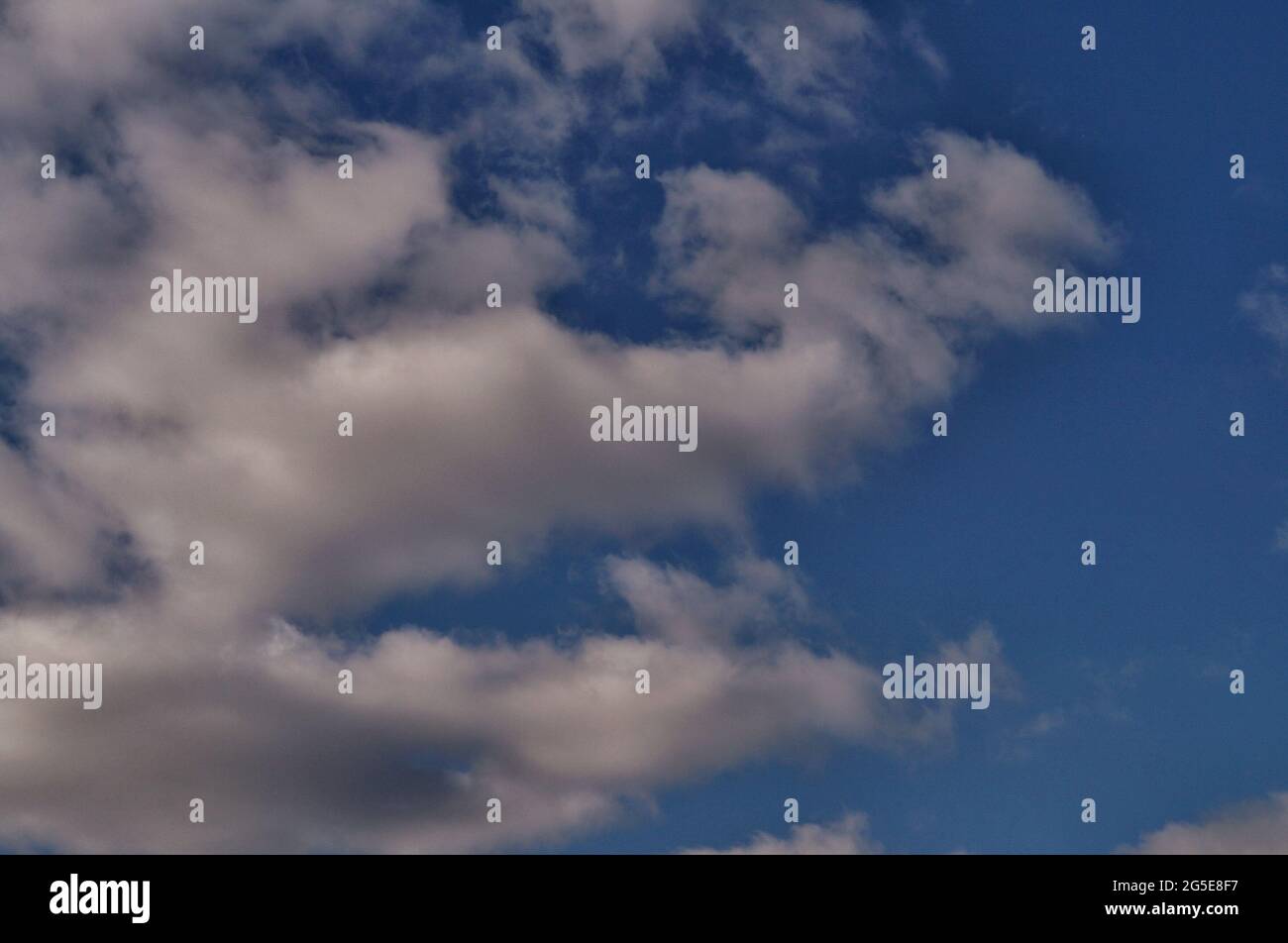 White and gray clouds in a blue sky. Nature Cloudscape Stock Photo - Alamy