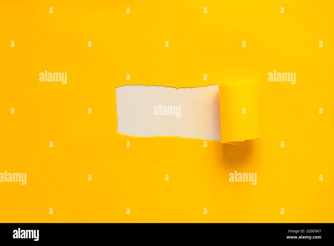 hole in a paper with torn side with a place for text, color surface ...