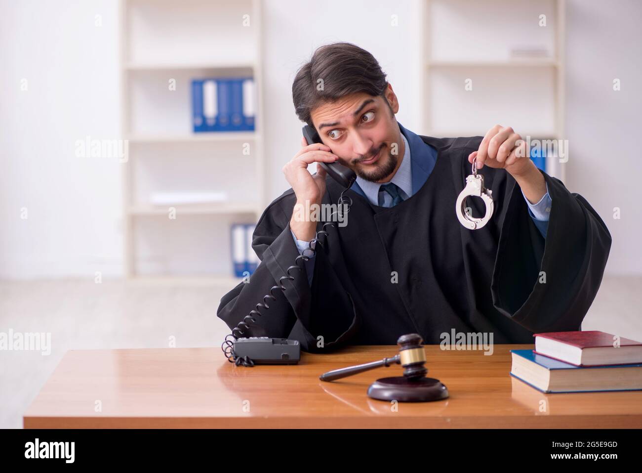 Young judge working in the courtroom Stock Photo - Alamy