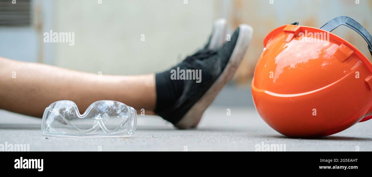 fallen worker on the floor with his helmet, accident injury Stock Photo ...