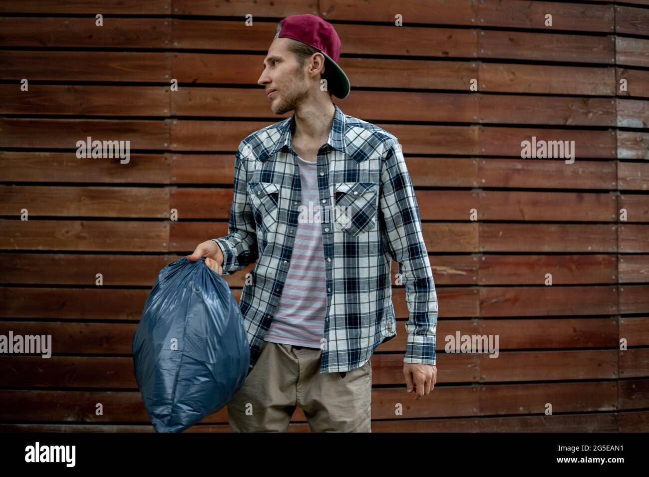 Man carrying a trash bin hi-res stock photography and images - Alamy