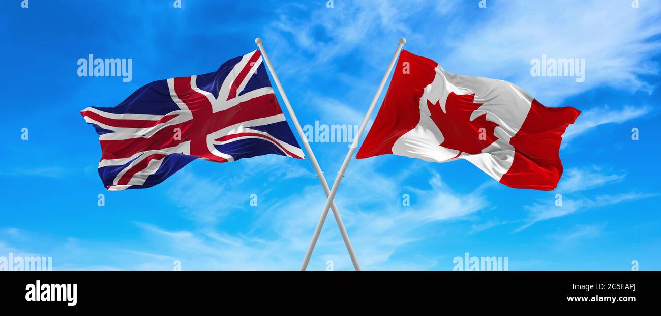flags of great Britain and canada waving in the wind on flagpoles ...