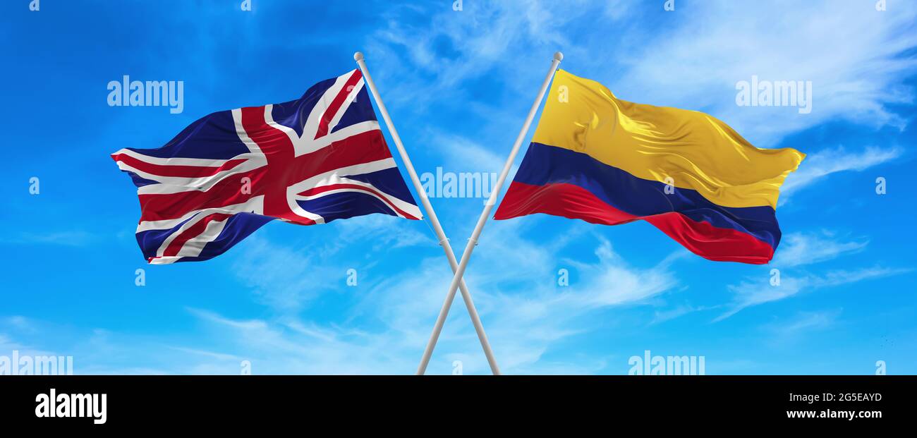 flags of great Britain and Colombia waving in the wind on flagpoles ...