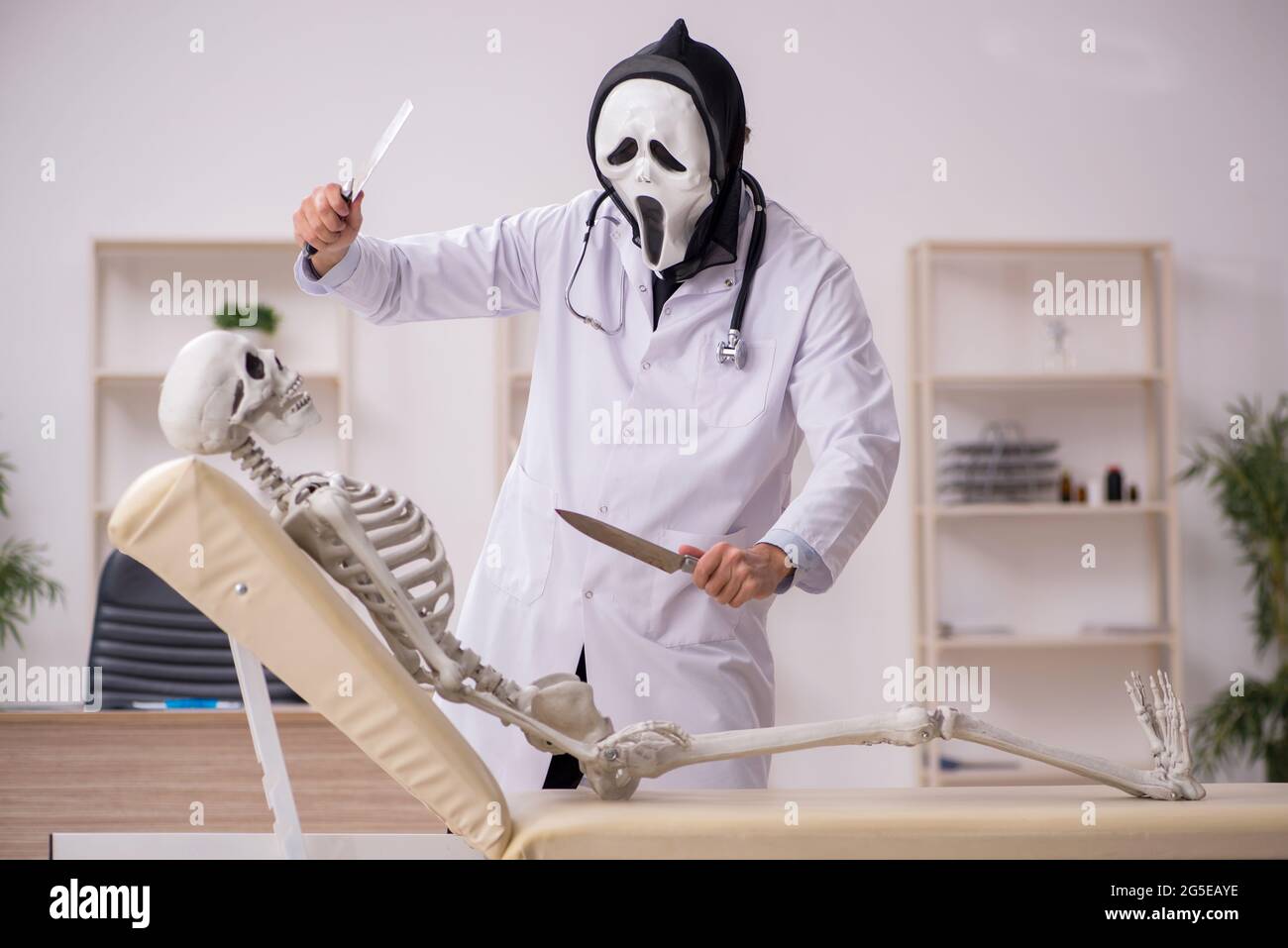 Devil doctor examining skeleton patient in the clinic Stock Photo - Alamy