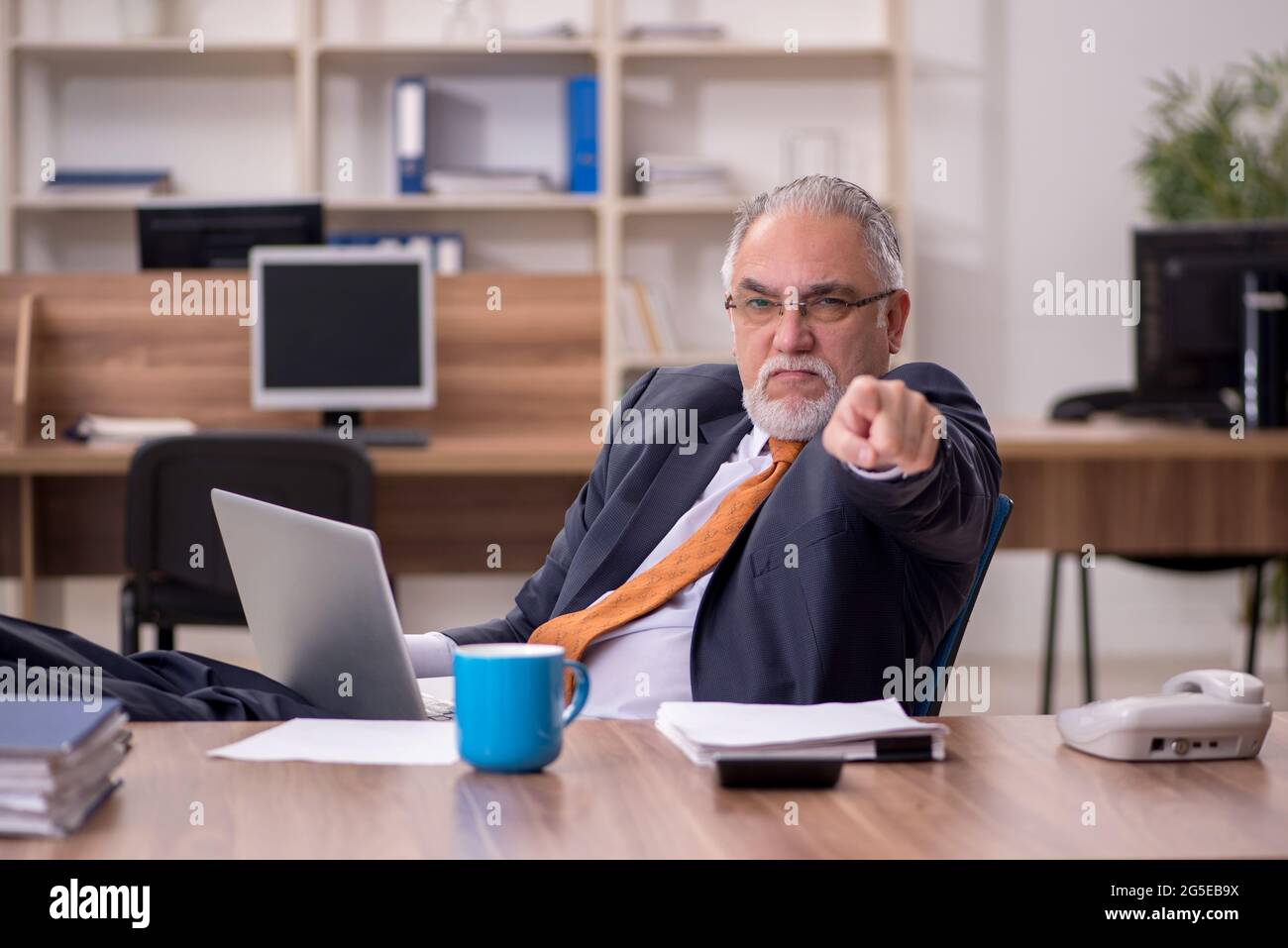 Old employee working in the office Stock Photo - Alamy