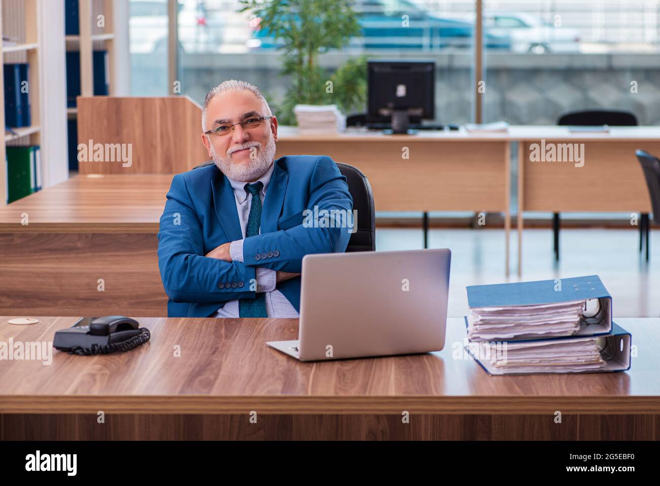 Old employee working in the office Stock Photo - Alamy