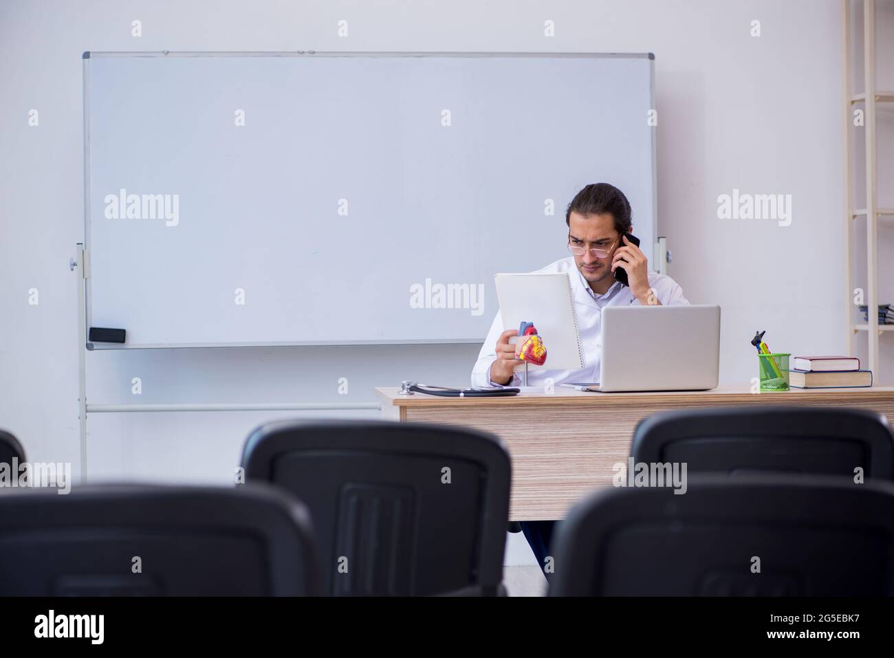 Young doctor giving seminar in the classroom Stock Photo - Alamy
