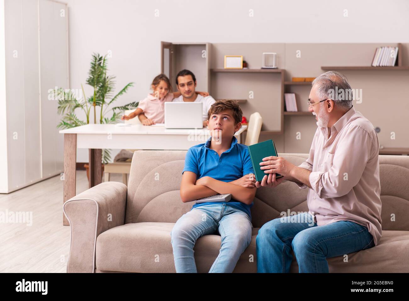 Three generations at home in early development concept Stock Photo - Alamy
